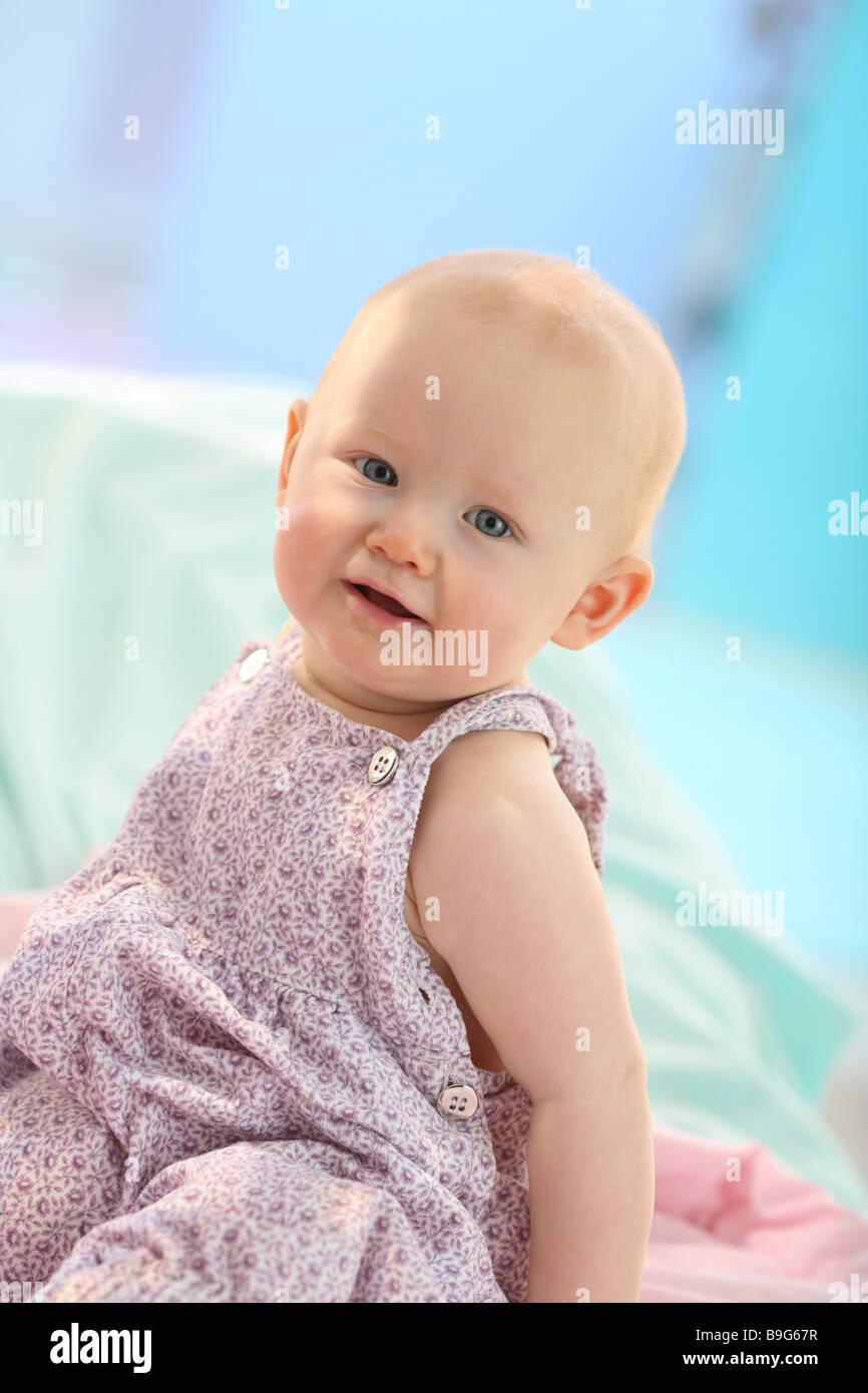 Baby sitting smiling frontal Stock Photo - Alamy
