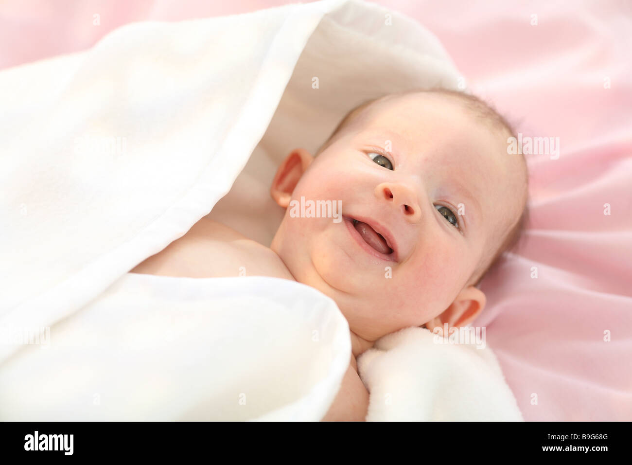 Baby lying supine position laughing blankets enveloped portrait 3 ...