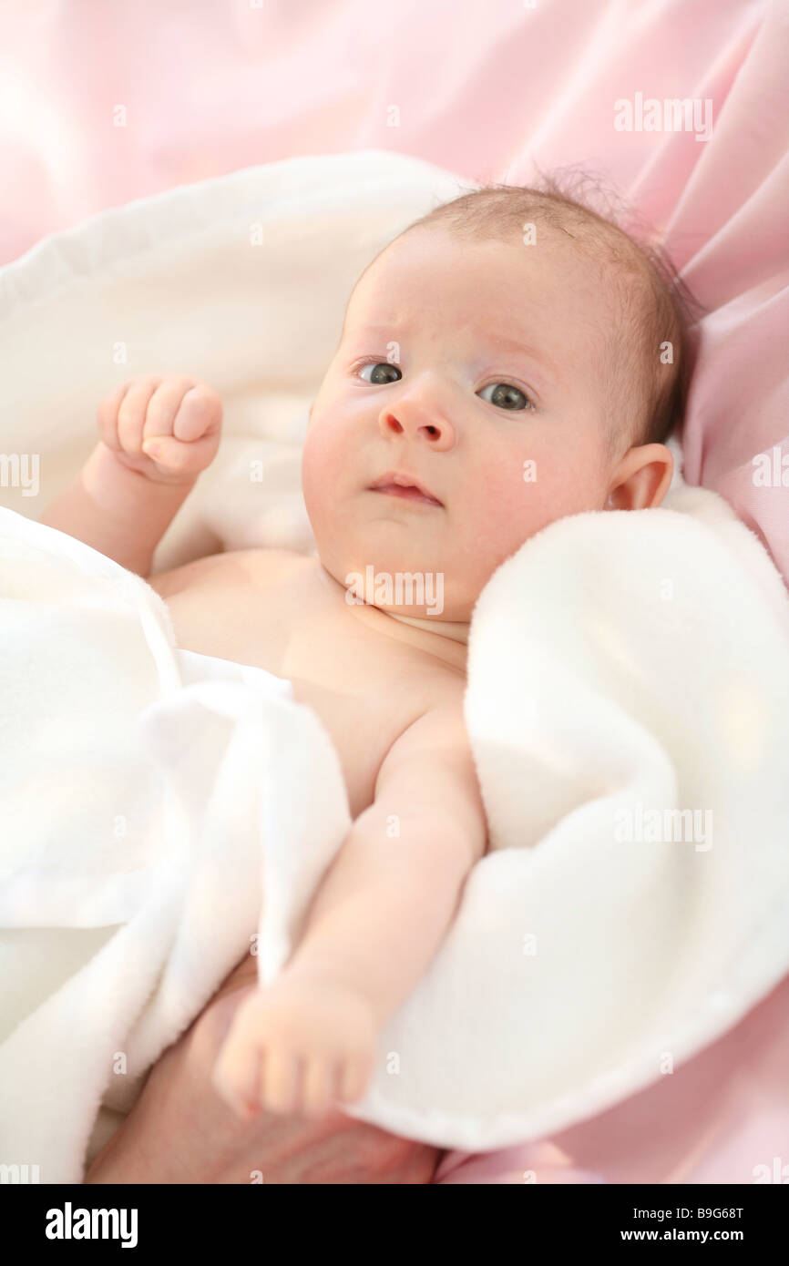 Baby lying supine position blankets portrait enveloped mother detail ...