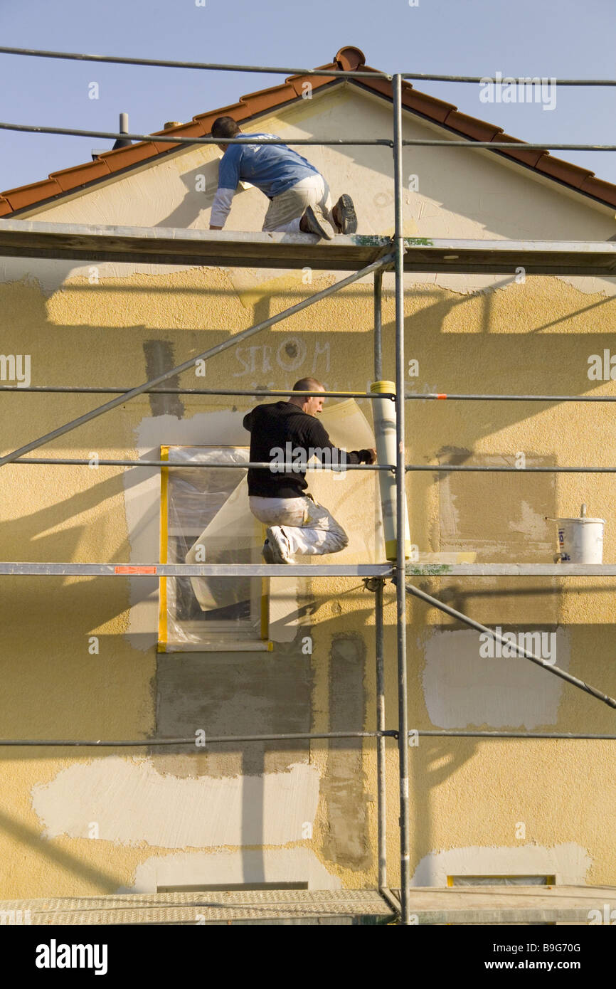 House-facade scaffolding plasterers work Stock Photo - Alamy