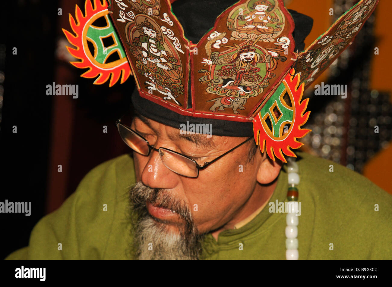 China Yunnan province Lijiang Man in traditional clothes doing ...