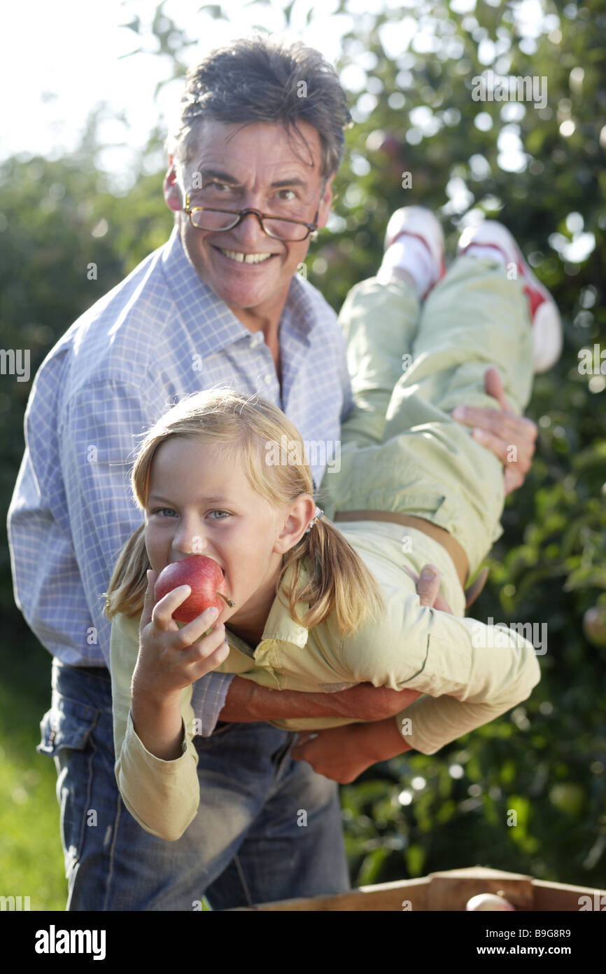 Garden father daughter frolic apple eating cheerfully series people man ...