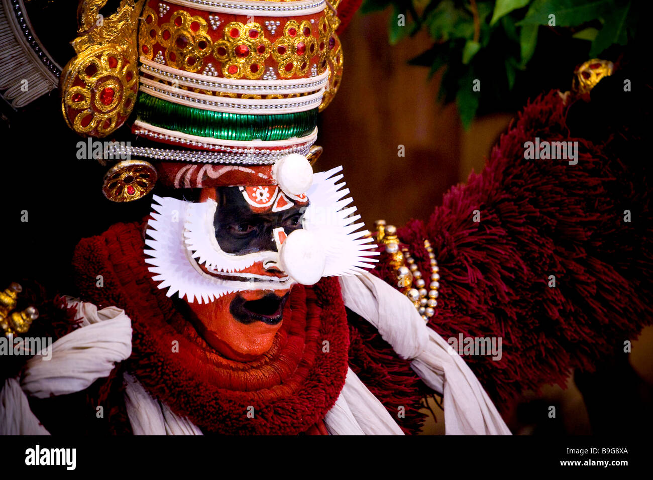 A Kathakali performer playing a demon or a Chuvanna Thaadi on stage in ...