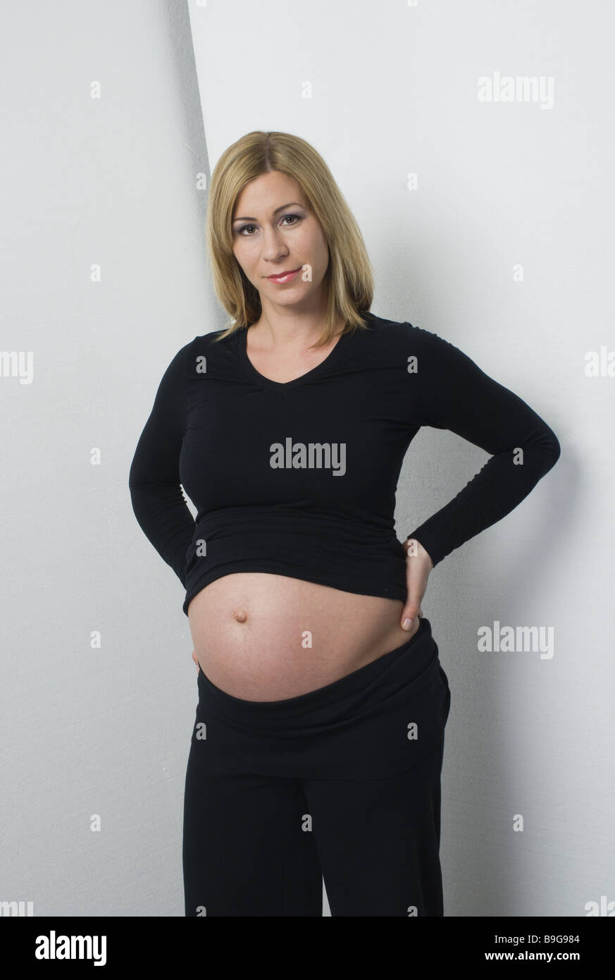 30-40 years baby-belly belly watching camera blond expectation family ...