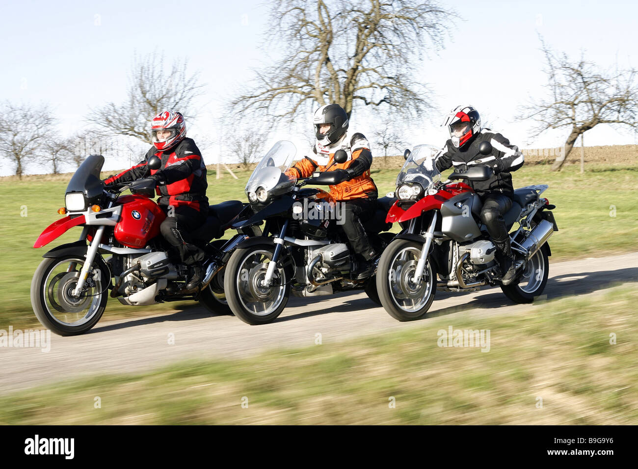 Country road motorcyclists three side by side autumn streets people ...