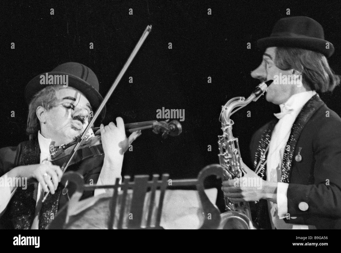 Clown musicians Alexandra Popova left and Gennady Kolpensky perform in ...