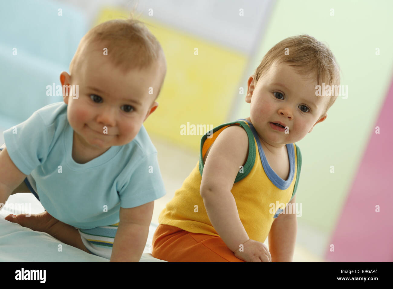 Babies sitting crawls side by side friends full-length 10 months ...