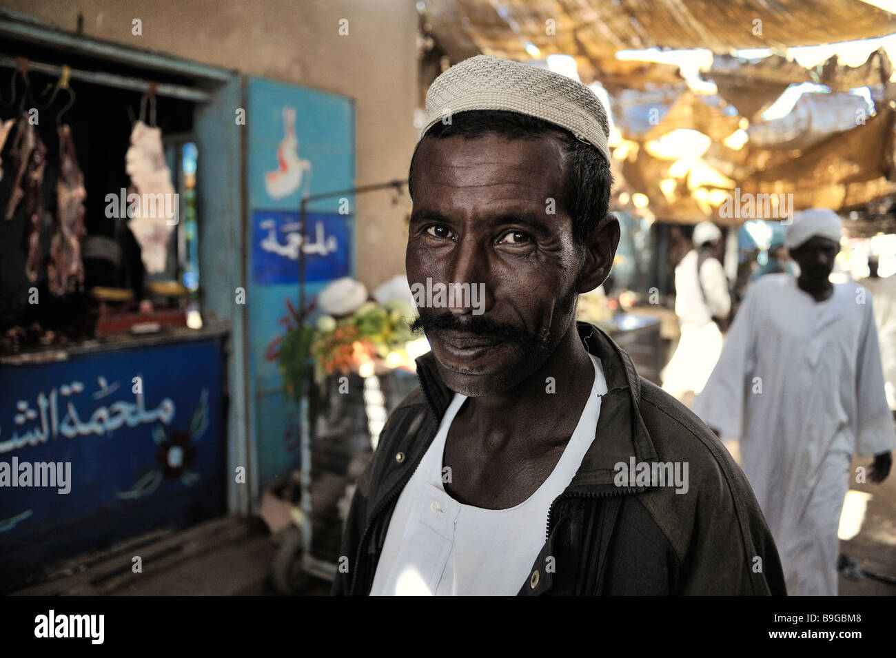 Sudanese man in front of shop, stall in town of Debba, northern Sudan ...