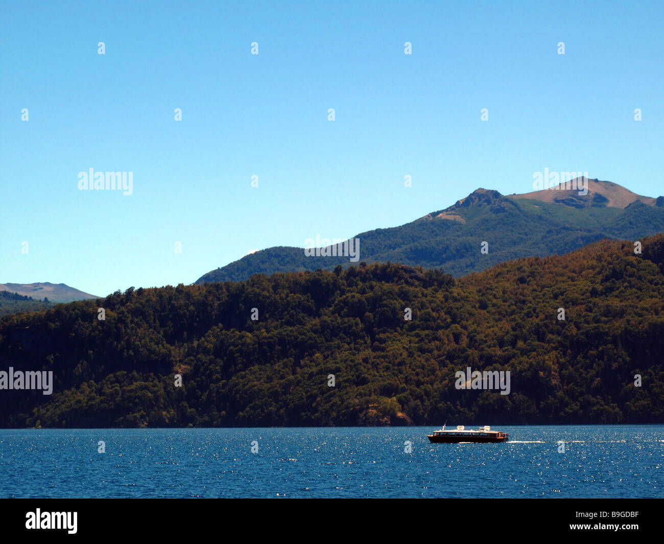 A tourist ship sailing at the lake Lacar, in the Lanin national park ...