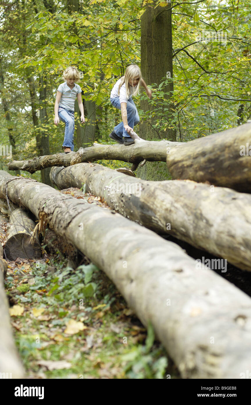 Children girl two forest cheerfully log balances laughs friends 8-12 ...