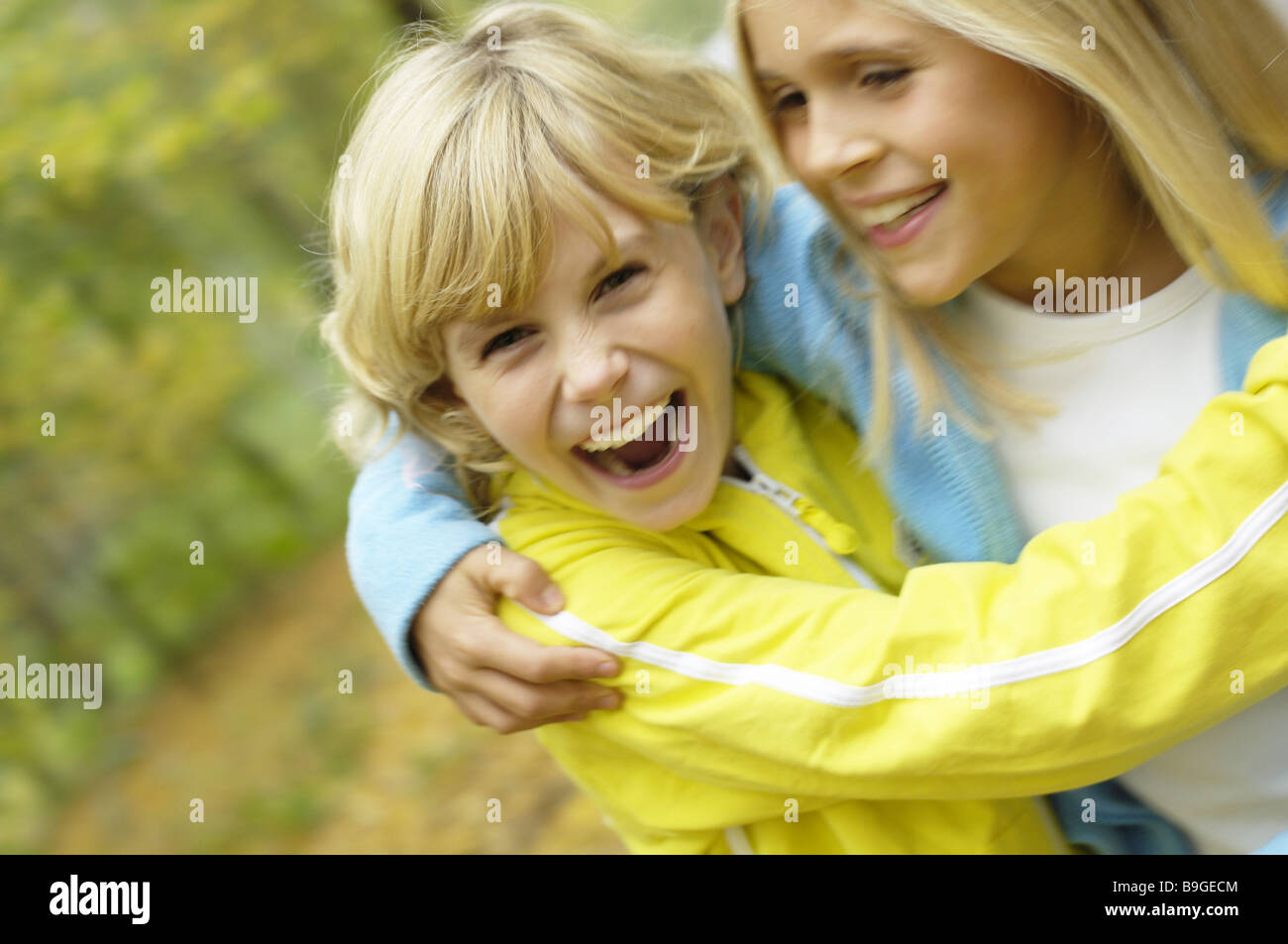 Children girl two cheerfully embrace laughs nature fun portrait friends ...