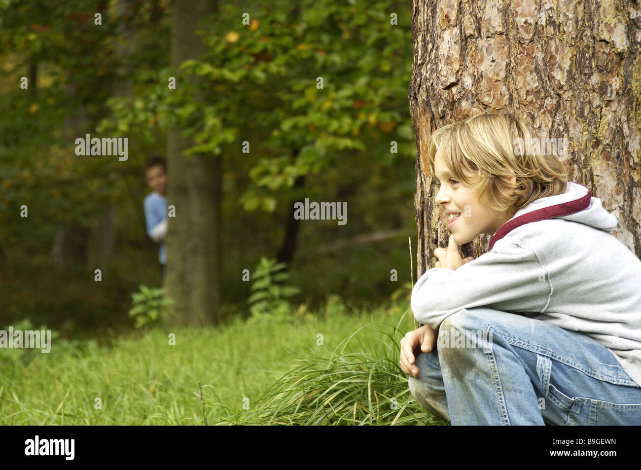 Children forest play boy log hiding joy fun smiling child boys 8-12 ...