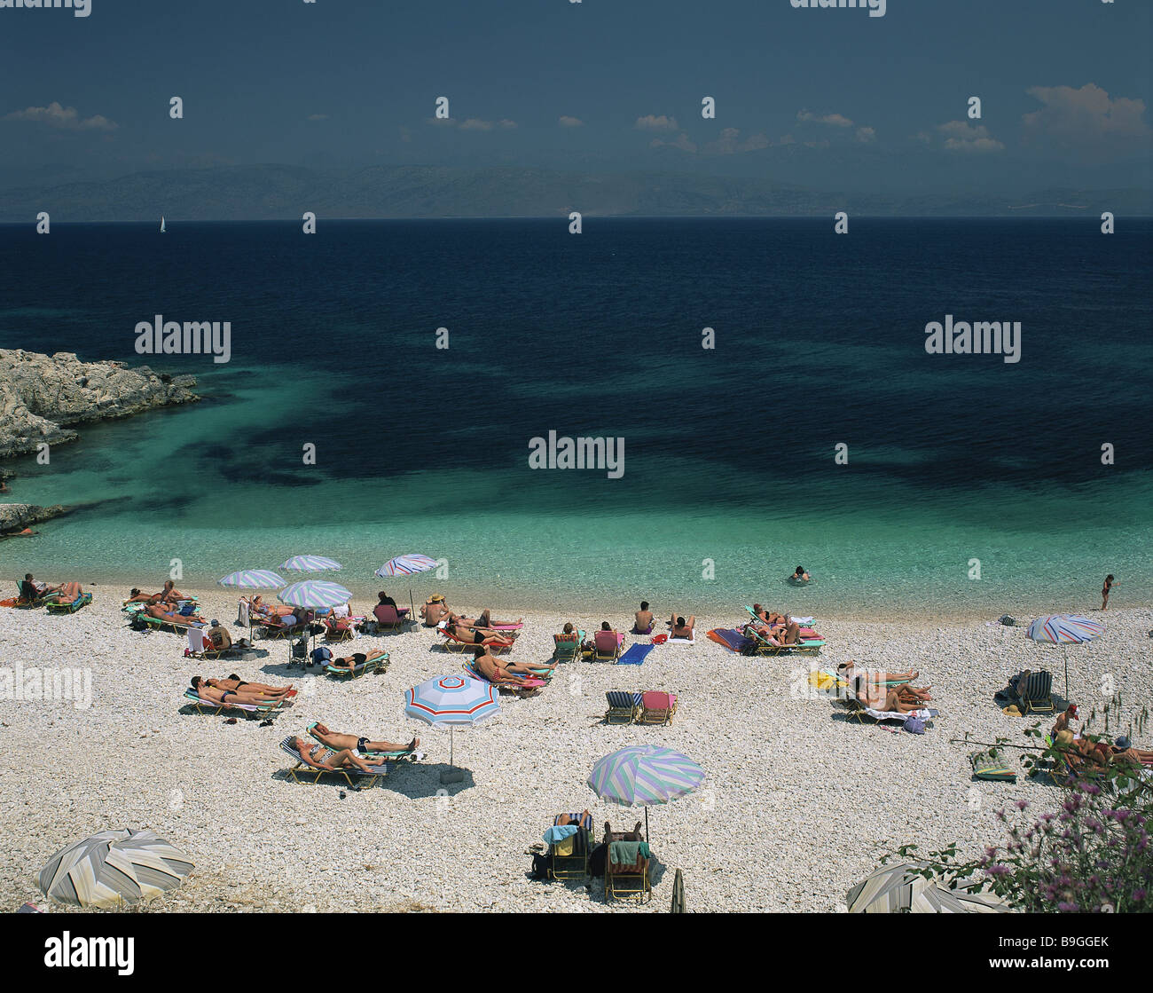 Greece island Corfu Kassiopi beach-scene swimmers lake coast bay beach ...