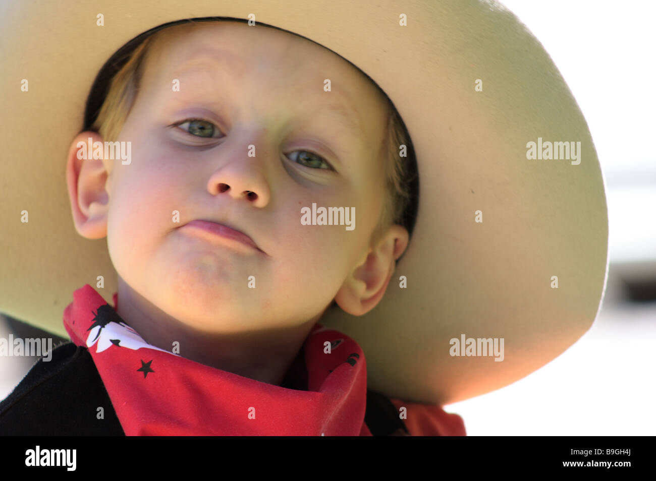young boy in cowboy had smirk on face Stock Photo - Alamy