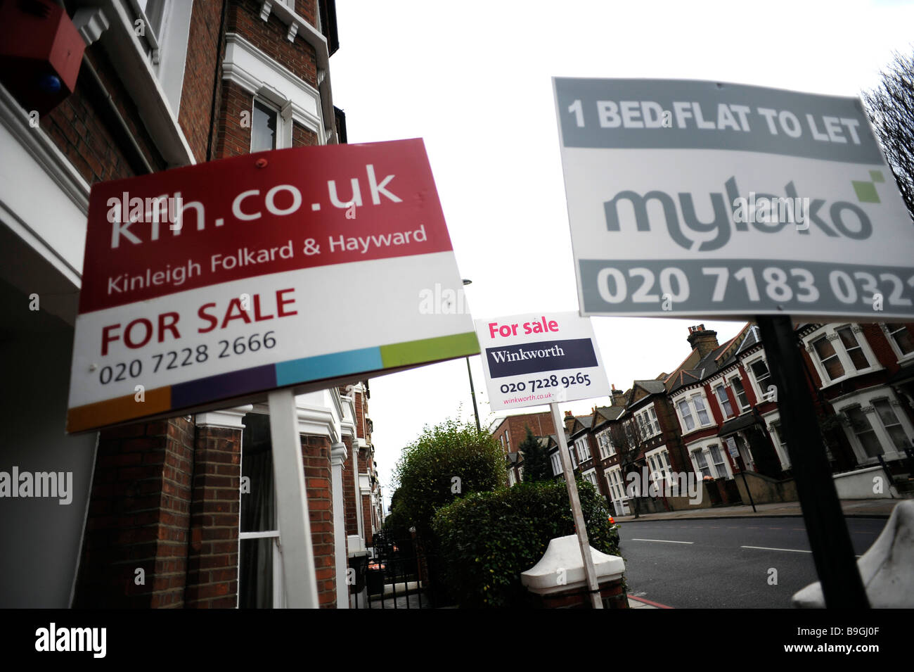 Real estate, for sale, to let, signs outside terraced flats in London ...