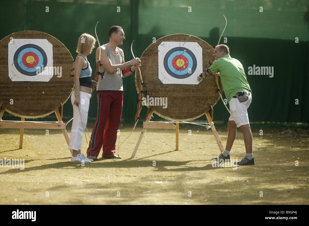 Group stands archery target sport full-length 30-40 years 31 year 40-50 ...