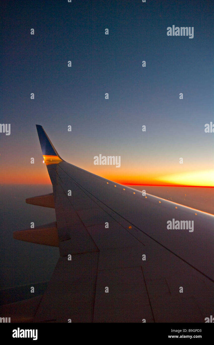 Jet wing sunset Stock Photo - Alamy