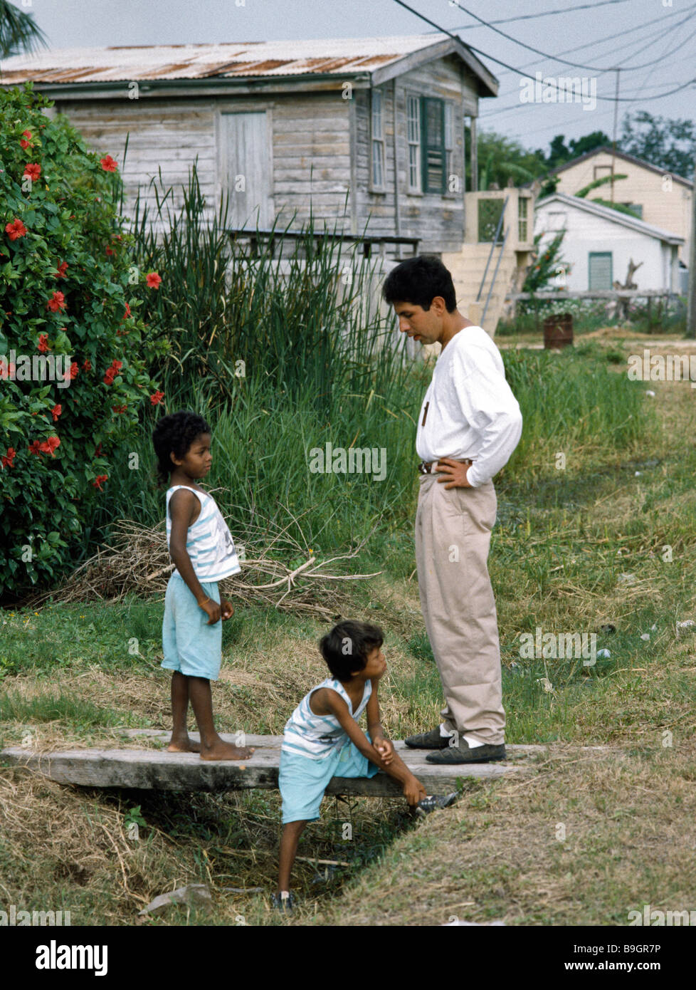 Adult talking to two young Belizean children in Corozal town, Belize ...
