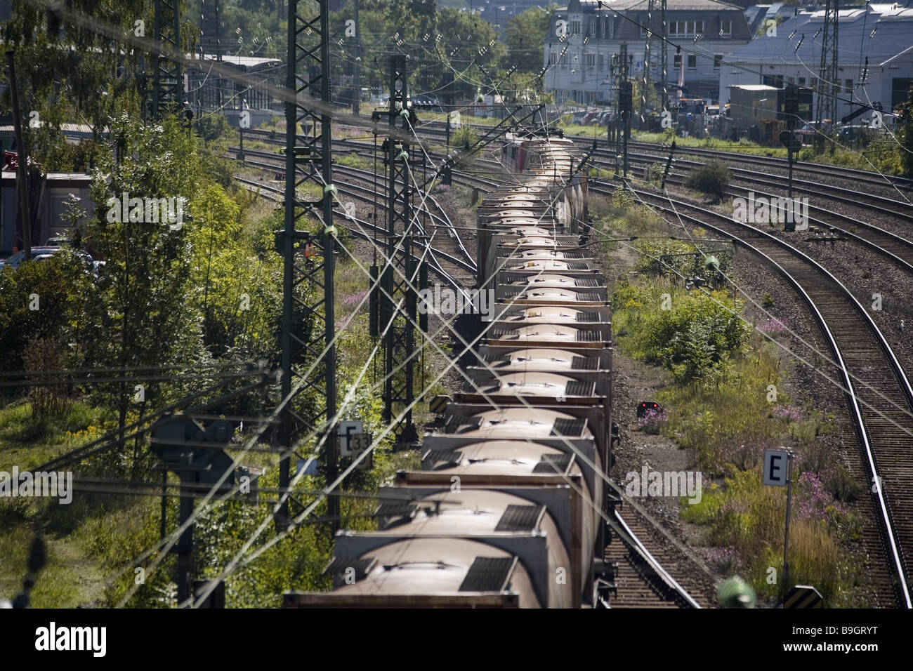 Railroad rails overhead cables freight train Stock Photo - Alamy