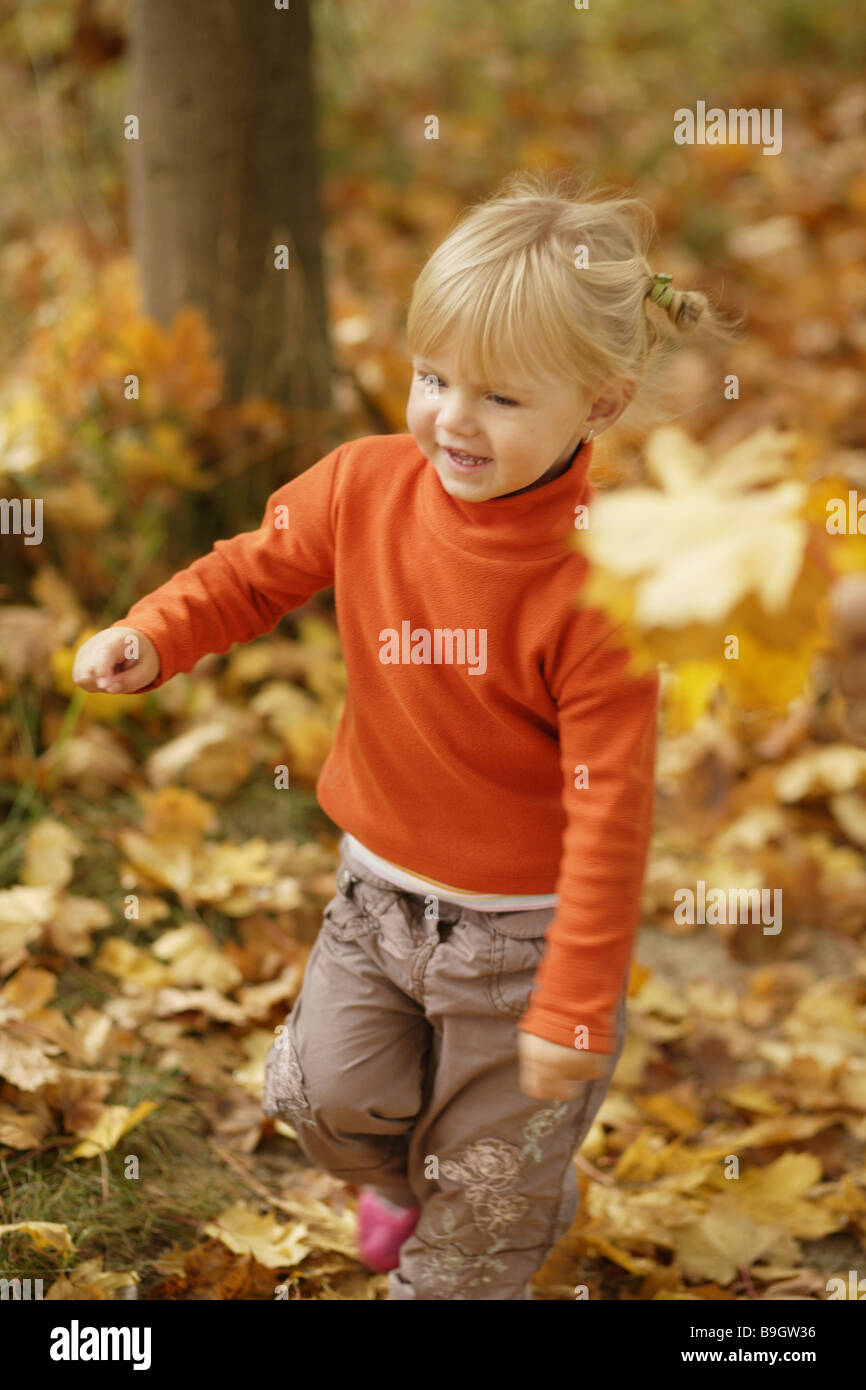 Forest child fall foliage running happy Stock Photo - Alamy