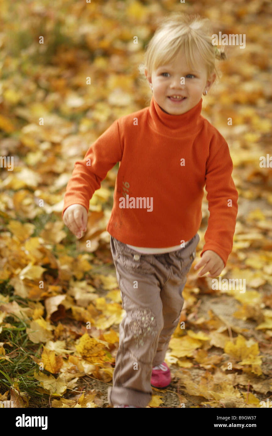 Forest child fall foliage running happy Stock Photo - Alamy