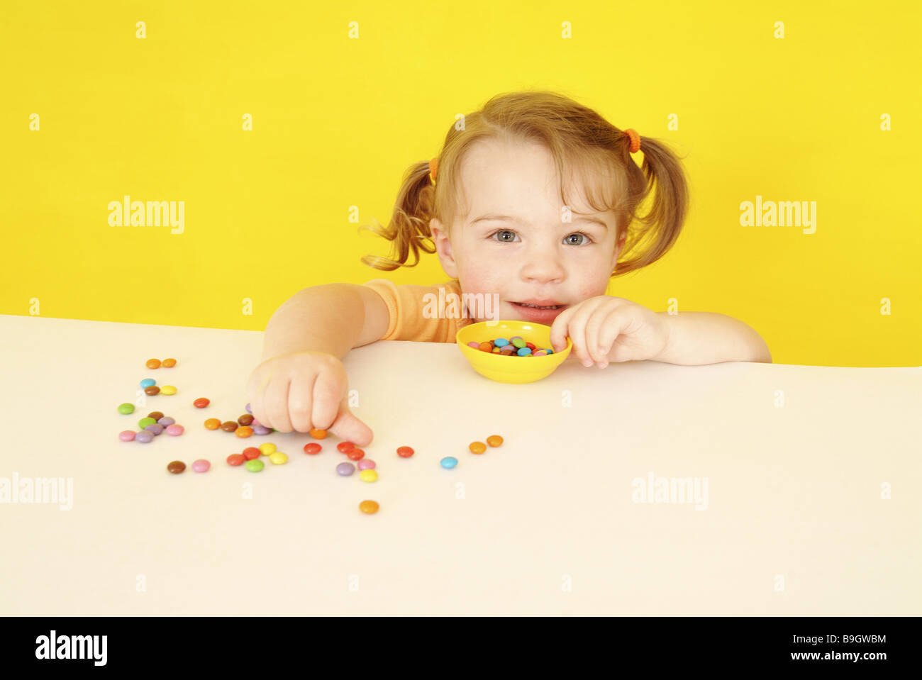 Child girl candies eating eating candy Stock Photo - Alamy