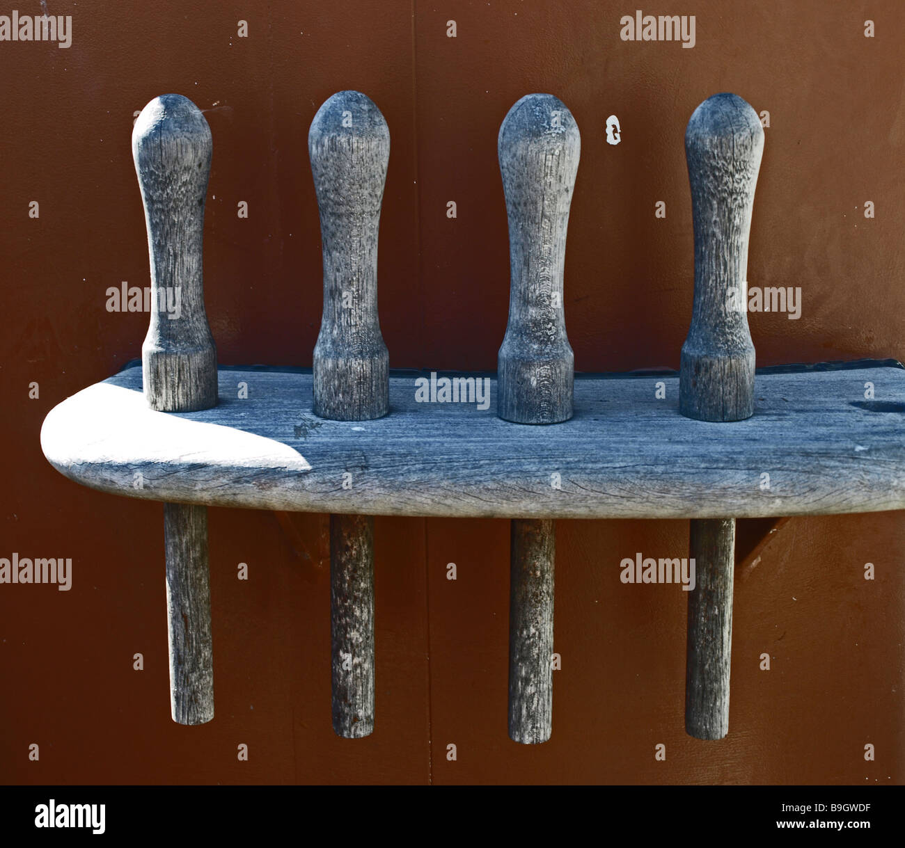 wooden pegs belaying pins used on tall-ship tall-ships in a holder four ...