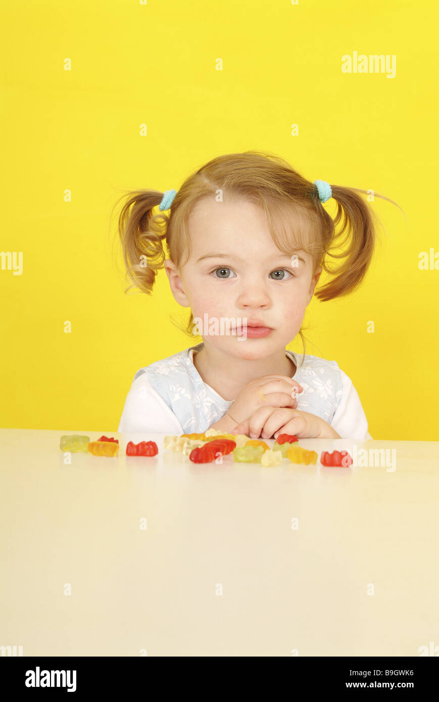 Child girl candies eating eating candy Stock Photo - Alamy