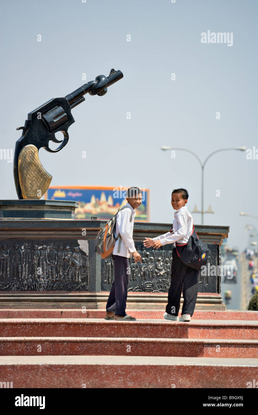 Khmer (Cambodian) schoolboys walk past-twisted-barrel-revolver monument ...