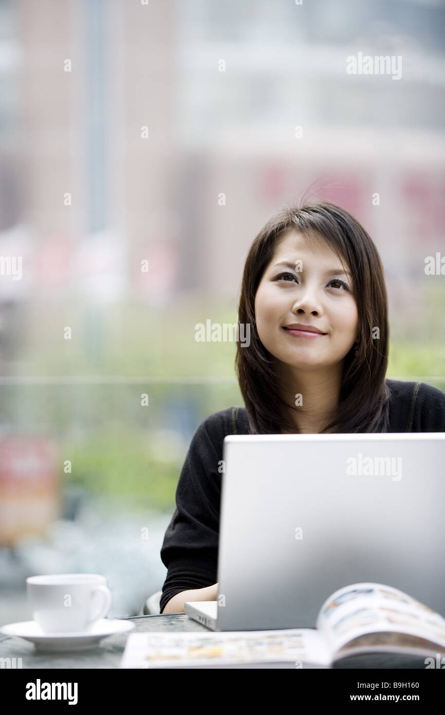 One young woman by coffee table portrait Stock Photo - Alamy