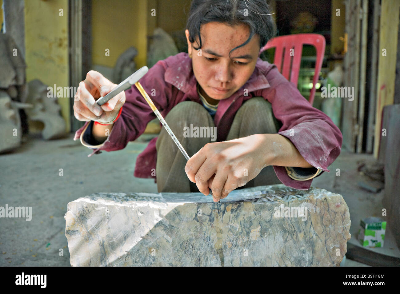Khmer woman stoneworker inscribes rock, Phnom Penh, Cambodia Stock ...