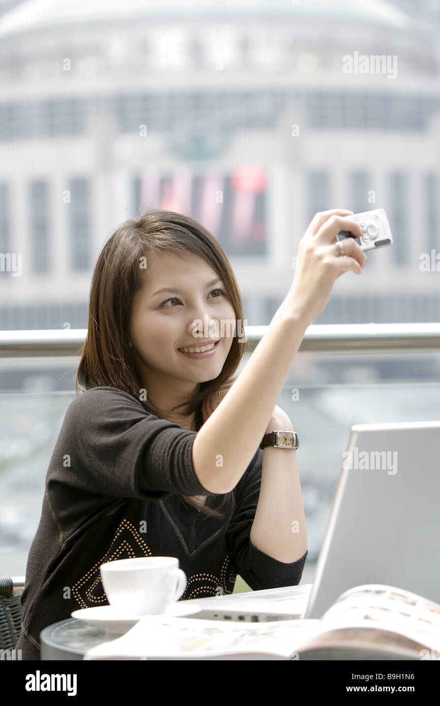 One young woman photographing herself with camera portrait Stock Photo ...