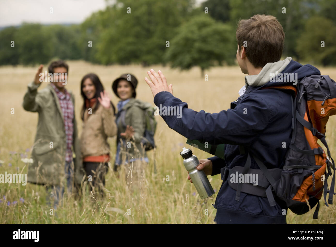 Group hikes leisure time nature grass waves outside 20-30 years ...