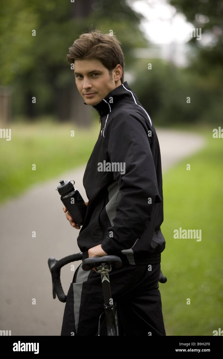 Man young biking sport looks back semi-portrait nature outside 20-30 ...