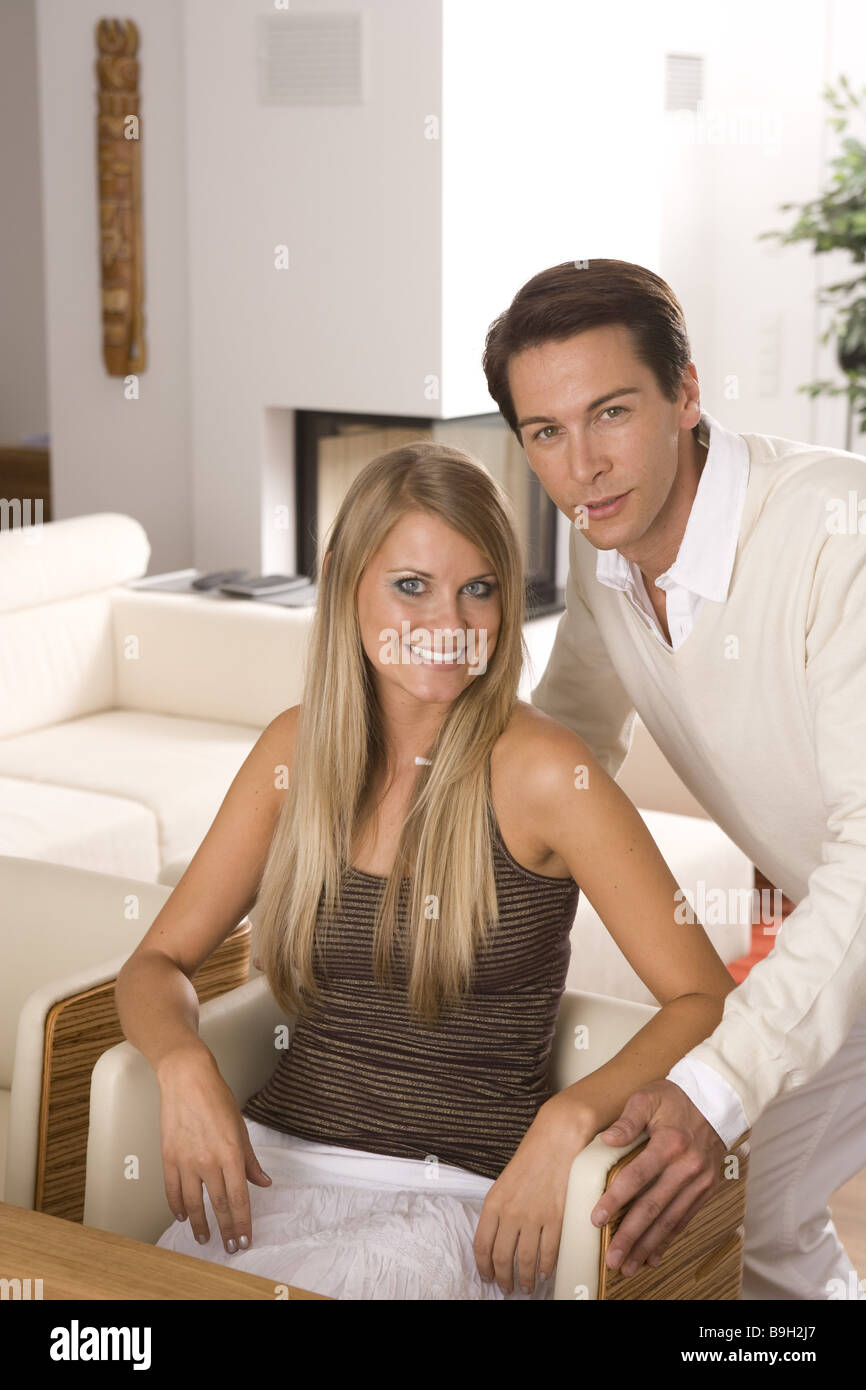 Mate smiling kindly at home interior 20-30 years 30-40 years gaze ...