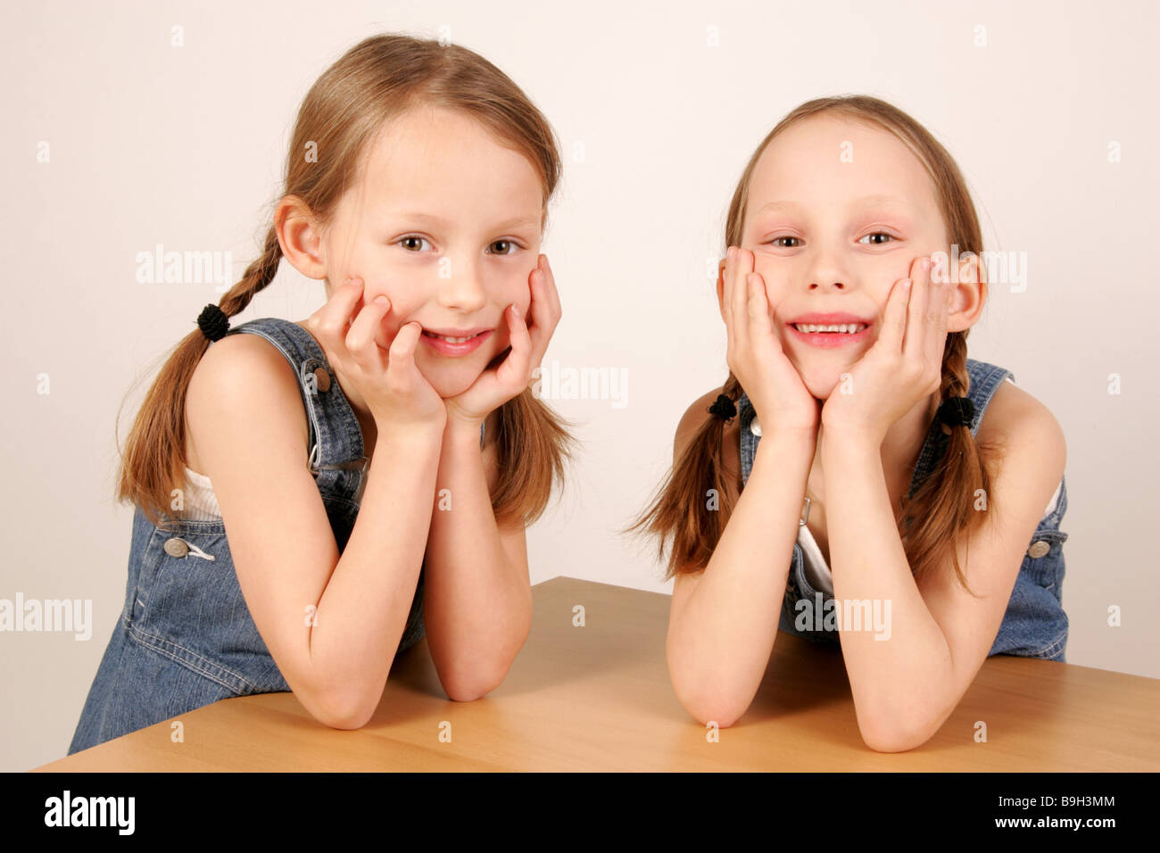 girl twins head hands resting smiling portrait series people children 6 ...