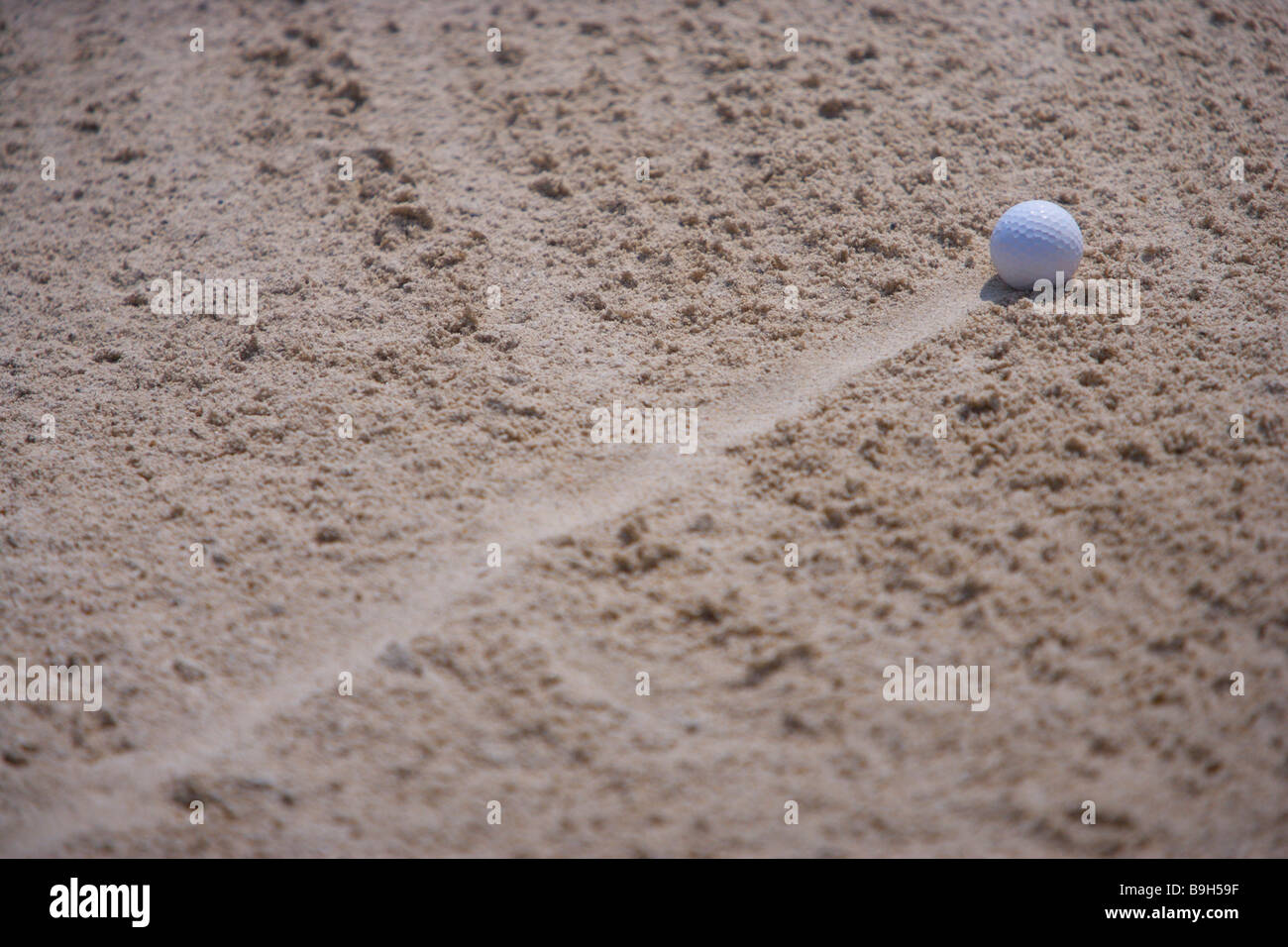 Golf ball in the sand trap Stock Photo - Alamy