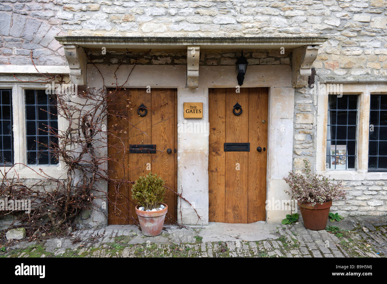 Double doors of The Gates Castle Coombe Wiltshire Stock Photo - Alamy
