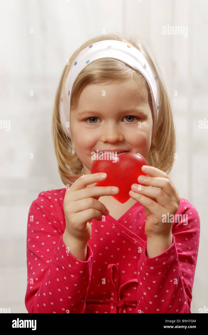 girl smiling heart holding portrait Stock Photo - Alamy