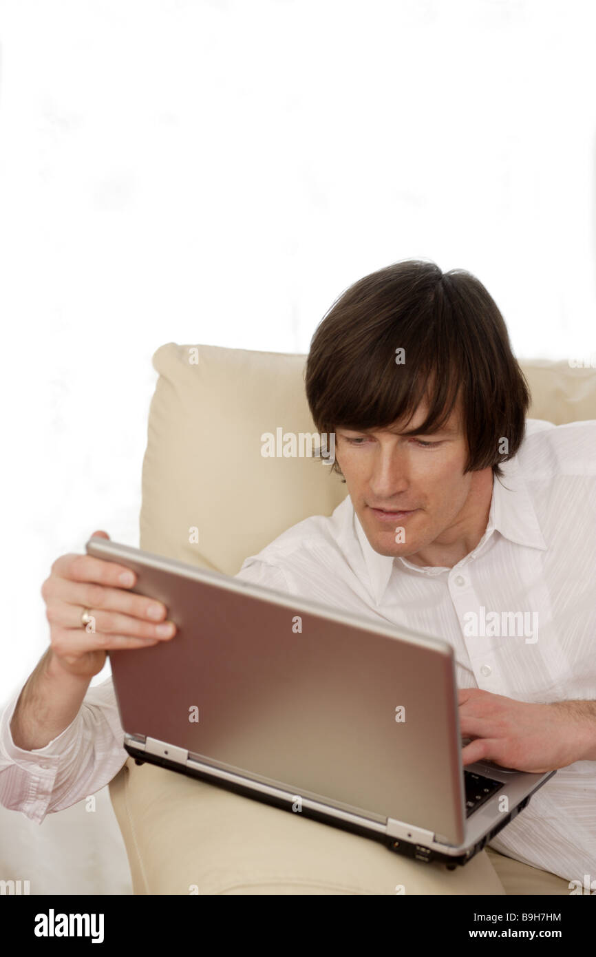 Man laptop sofa sitting Stock Photo - Alamy
