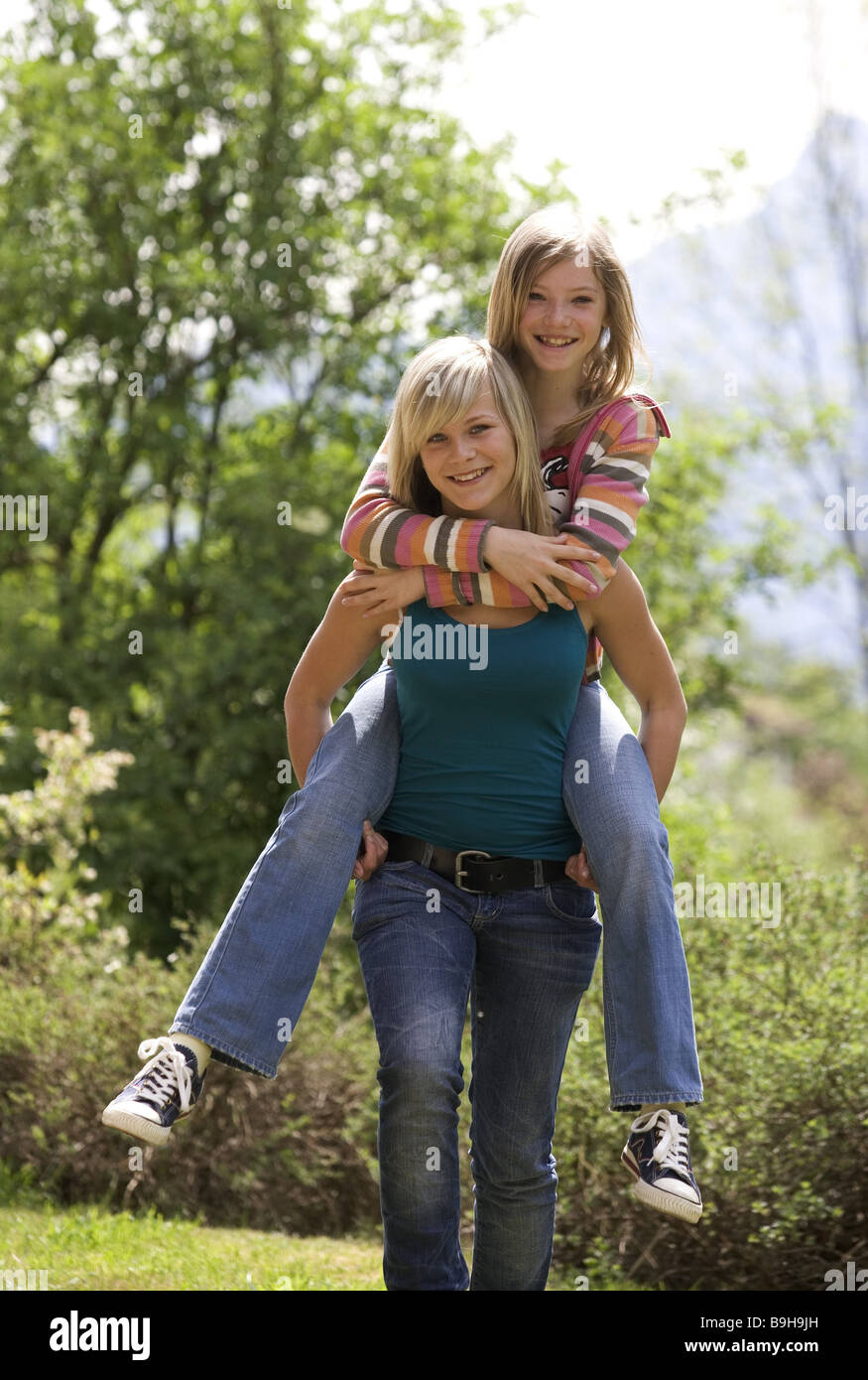 girl teenagers two cheerfully piggyback summer outside 13 years 13-15 ...