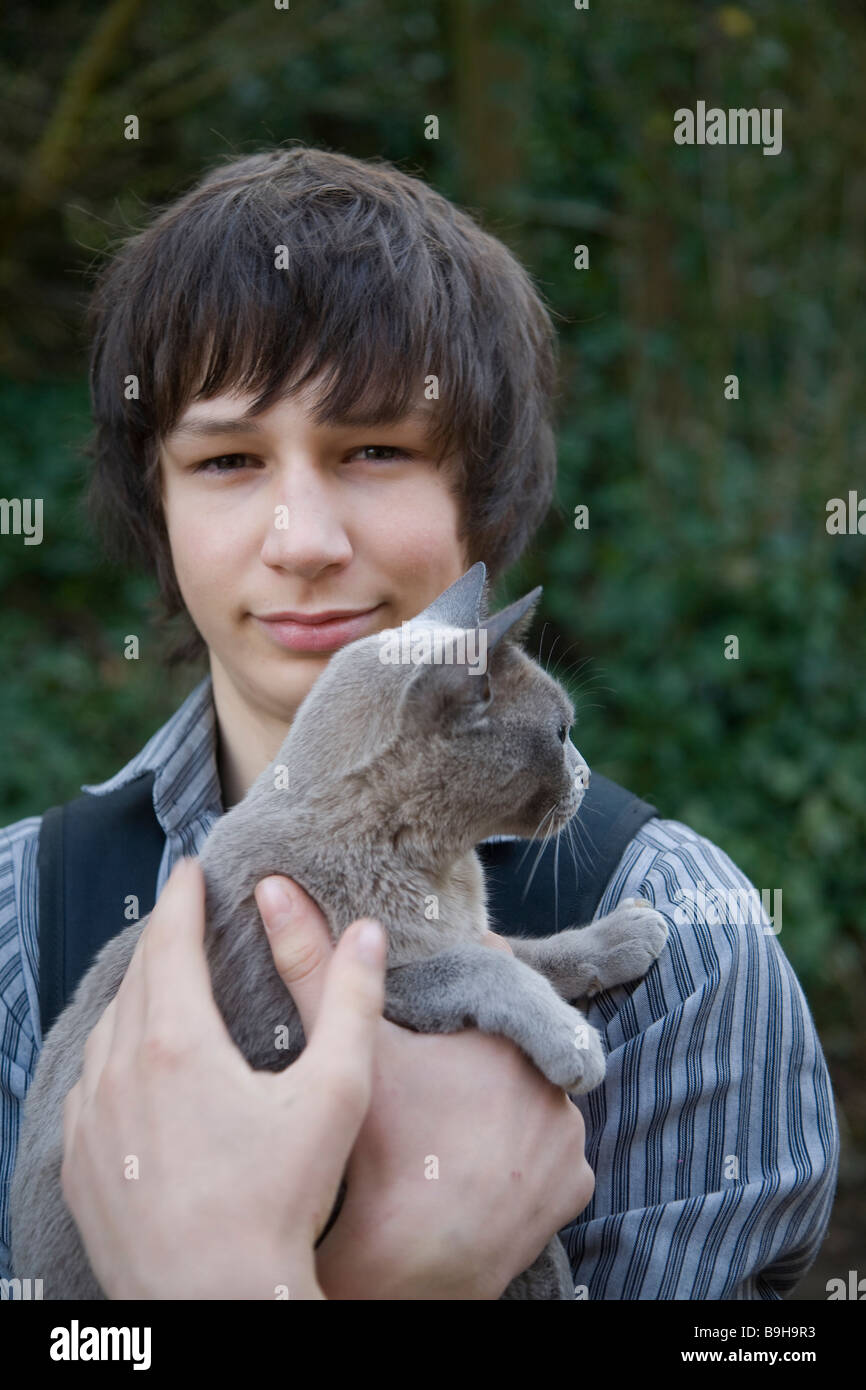 Model released portrait of teenage boy holding pet cat Stock Photo - Alamy