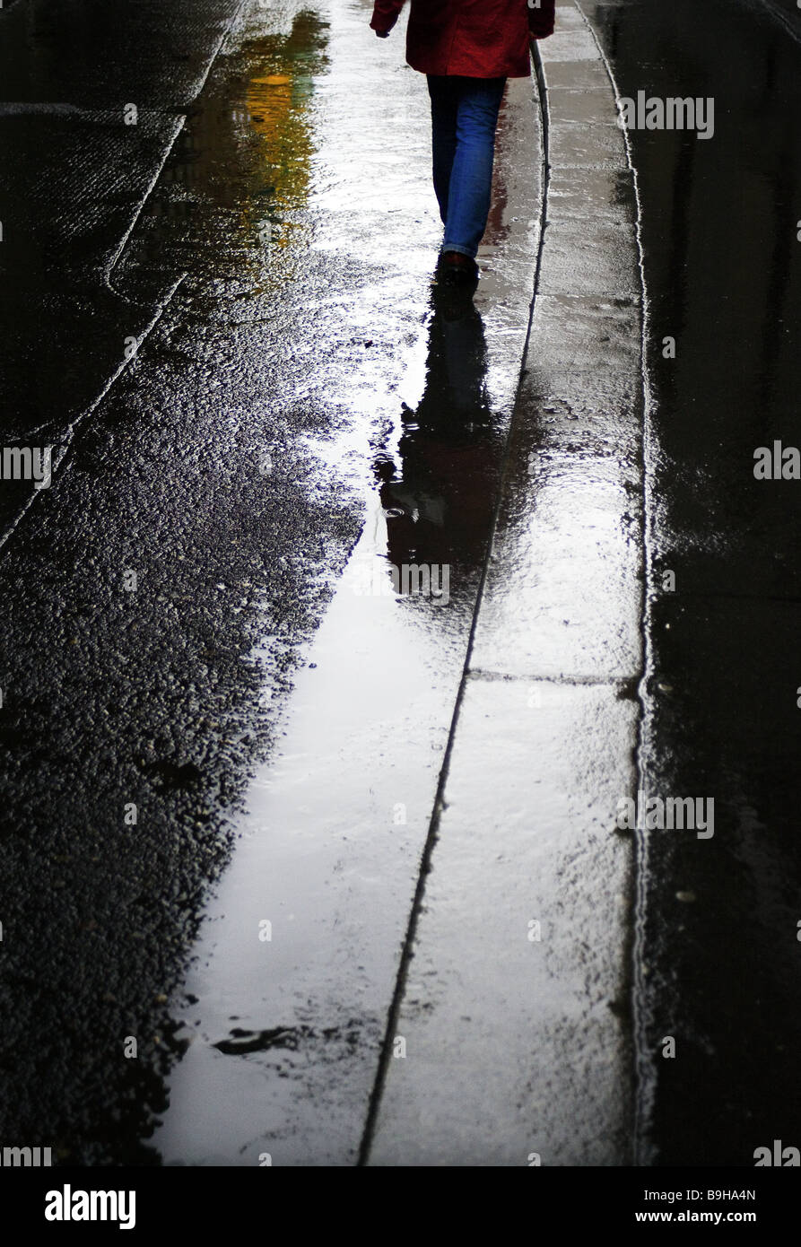 Alley pedestrian detail legs back view rain side streets wet puddles ...