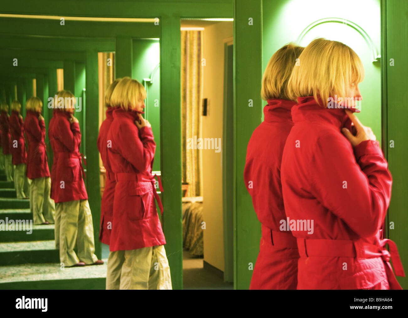 Hall woman coat at the side reflection many times people young blond ...