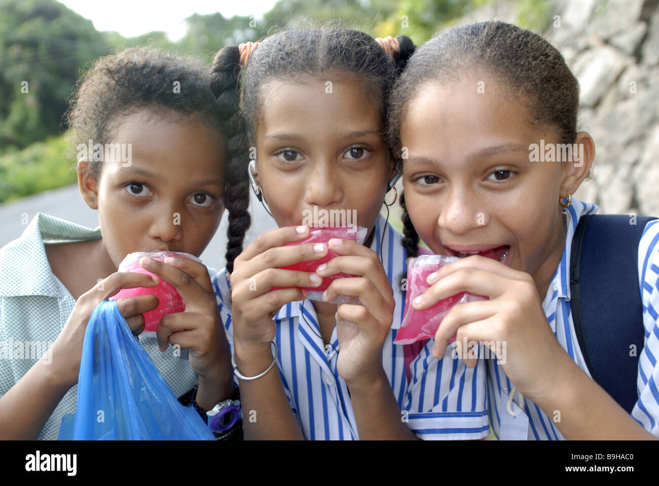 Seychelles island Mahe schoolchildren girl ice eats cheerfully portrait ...