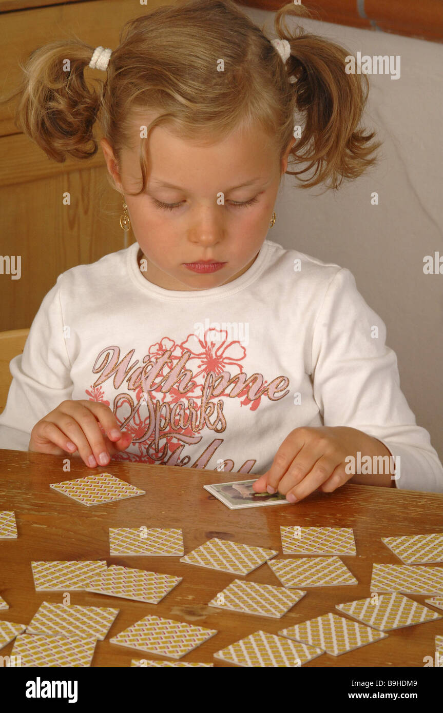 girl concentrates memory plays portrait people child childhood blond ...