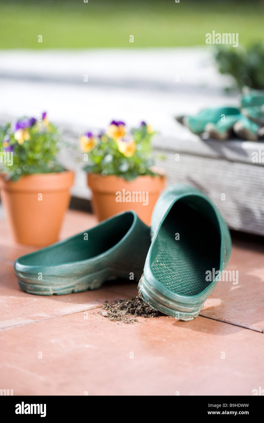 Garden-shoes terrace symbol planting time Stock Photo - Alamy