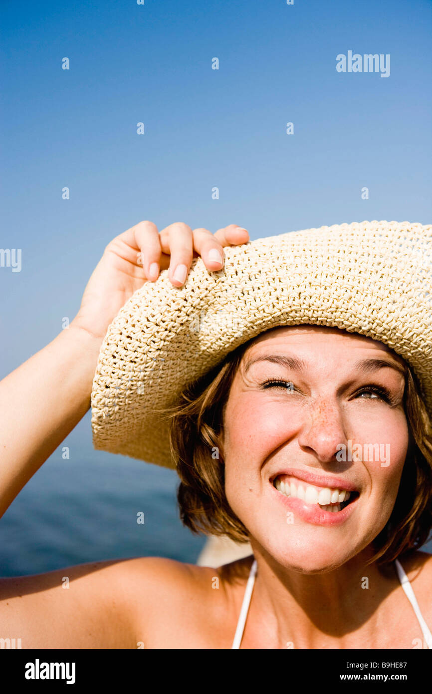Woman with hat smiling Stock Photo - Alamy