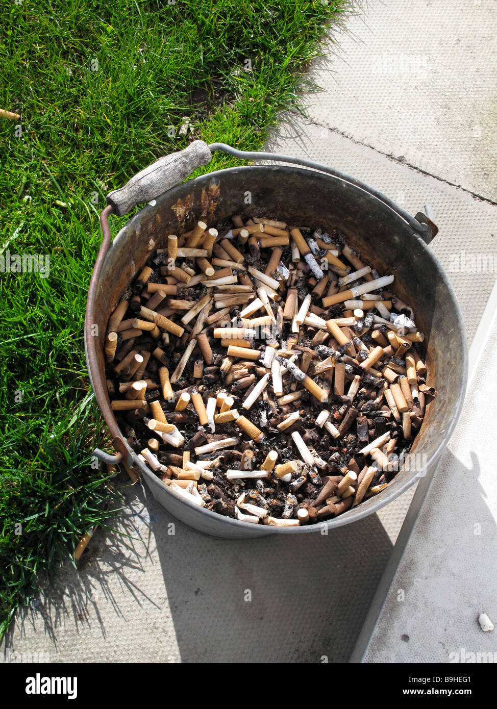 Cigarette ends in bucket Stock Photo - Alamy
