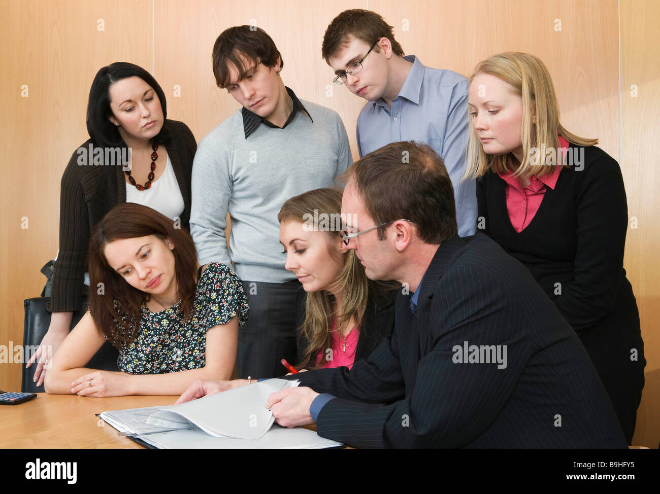 Colleagues looking at report Stock Photo - Alamy